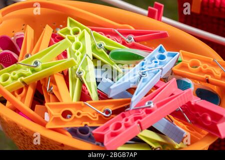 Set of plastic clothespins with hanging basket isolated on white ...