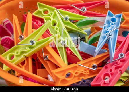 Set of plastic clothespins with hanging basket isolated on white ...