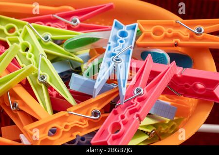 Set of plastic clothespins with hanging basket isolated on white ...