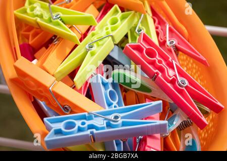 Set of plastic clothespins with hanging basket isolated on white ...