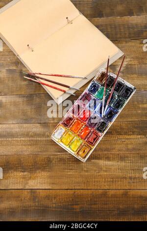 Composition with brushes, watercolors on wooden palette, isolated on ...