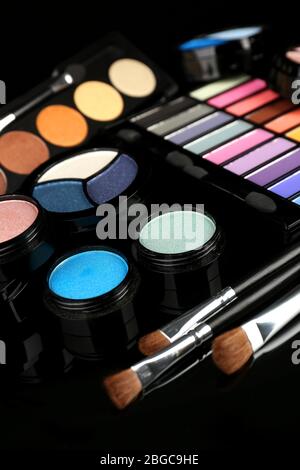 Bright eye shadows on black background Stock Photo - Alamy