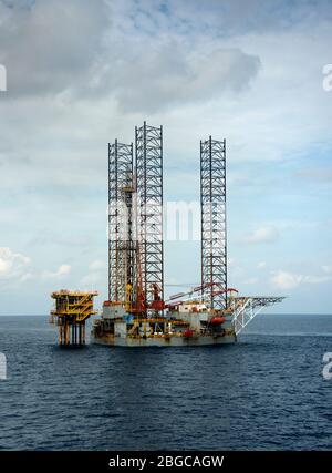 Offshore oil installation or rig with jack up drilling rig alongside ...