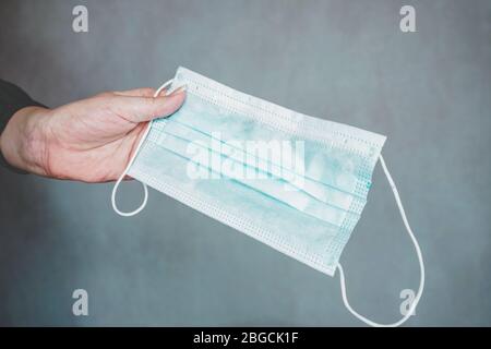 Someone holding a traditional med face mask Stock Photo - Alamy