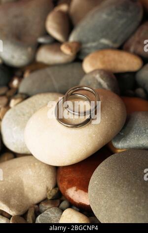 Wedding rings on rocks close-up Stock Photo - Alamy