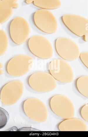 Flat lay. Unbaked Easter sugar cookies on a white table Stock Photo - Alamy