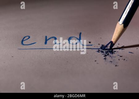 Word End and breaking pencil on paper, close up Stock Photo - Alamy