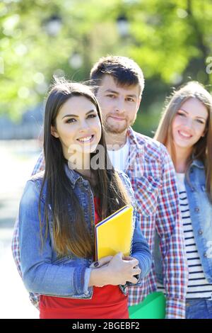 Happy students in park Stock Photo - Alamy