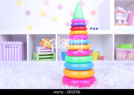 Plastic toy pyramid in children room Stock Photo - Alamy