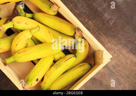Bunch of mini bananas in wooden box isolated on white Stock Photo - Alamy