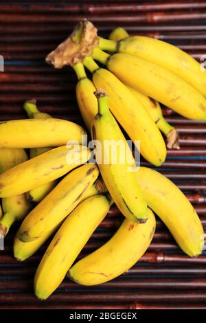 Bunch of mini bananas on bamboo mat background Stock Photo - Alamy