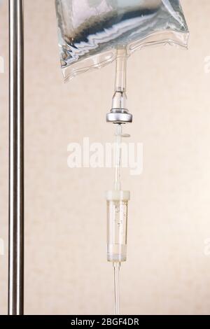 Disposable infusion set on wall background Stock Photo - Alamy