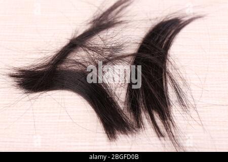 Cut hair on tile background Stock Photo - Alamy