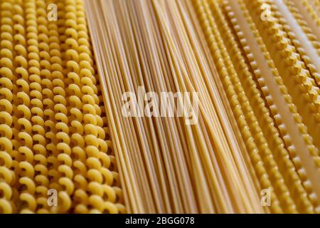 A closeup shot of dried long cut meat hanging on the thin thread on the ...