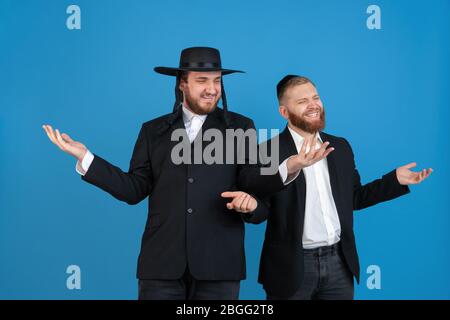 Pointing, greeting. Portrait of a young orthodox jewish men isolated on ...