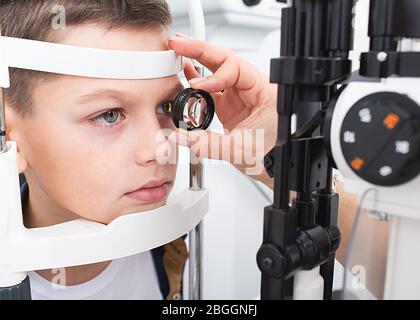 Checking boy's eyesight with binocular slit lamp, close-up. Vision ...