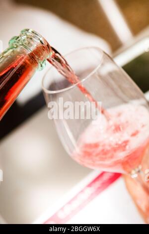 Bottle of red wine with wineglass. Water splash and droplet on the ...