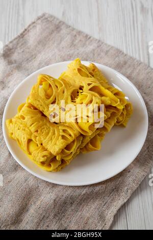 Homemade Net Crepe Roti Jala on a white plate on a black background ...
