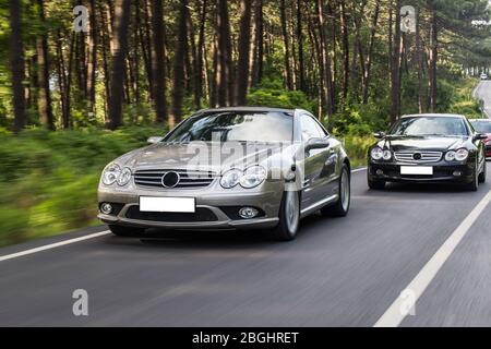 Chasing cars landscape drive in the sunset Stock Photo - Alamy