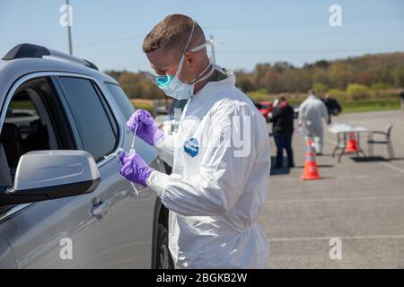 A health worker stands by a drive-through COVID 19 testing post amidst ...