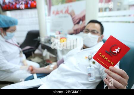 A donator gives out blood for saving lives at a bloodmobile, Shanghai ...