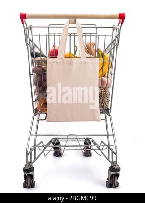 Top view of shopping bag near gift box and envelope on yellow ...