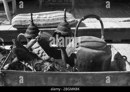 A seared kettle on glowing woods. Making coffee for tourists on the ...