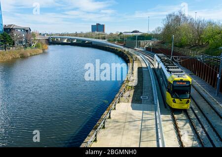 Metrolink tram alongside the Manchester Ship Canal on the opening day ...
