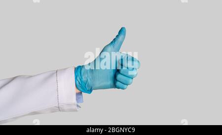 Hand in rubber gloved shows like sign Stock Photo - Alamy