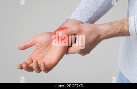 Wrist pain concept. Sore spot highlighted in red Stock Photo - Alamy