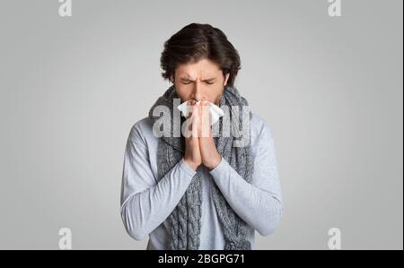 sick man with a scarf around his neck flu health problems light ...