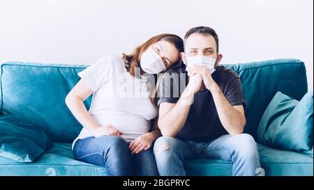 family in protective masks quarantined. Normal life with coronavirus ...