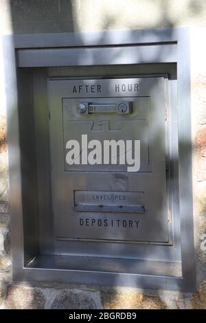 Metal After Hour Depository box attached to brick wall Stock Photo - Alamy