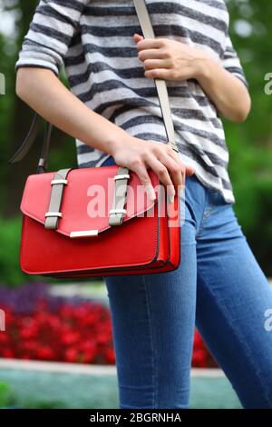 Girl with bag over his shoulder outdoors Stock Photo - Alamy