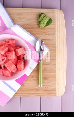 Plate, board with slices of watermelon, napkin and knife on white ...