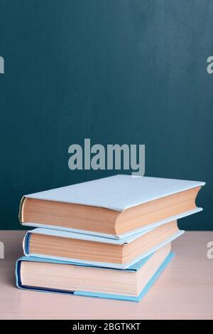 Three exercise books on the colorful wooden background Stock Photo - Alamy