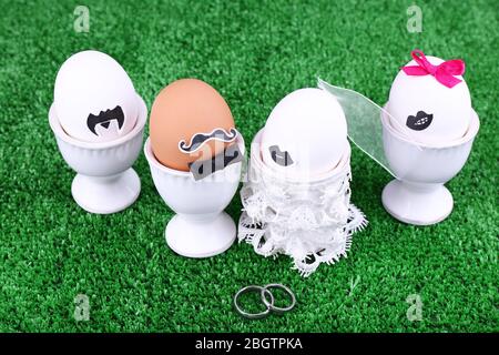 Egg bride and bridegroom with guests on green background Stock Photo ...