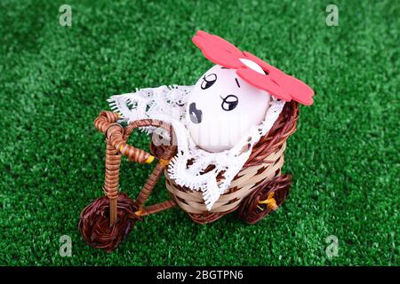 Egg riding bicycle on green background Stock Photo - Alamy