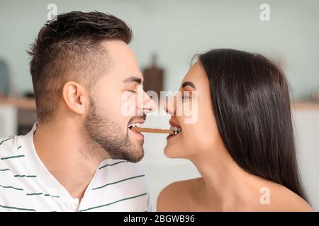 Couple eating chocolate Stock Photo - Alamy