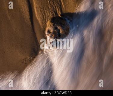 Beach pebble and swirling sea- Mundesley, December 2017 Stock Photo - Alamy