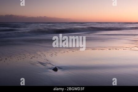 Morning at Mundesley beach. Colouful dawn over low tide beach and ...