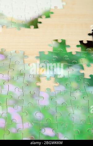 Puzzles with beautiful landscape on it on wooden table Stock Photo - Alamy