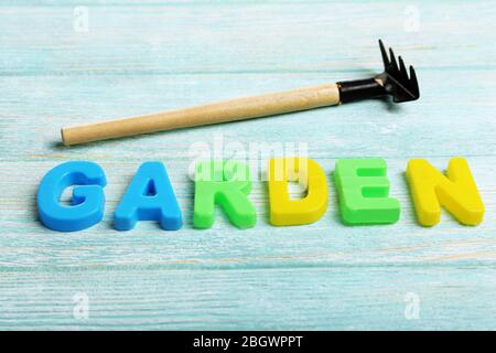 Garden word formed with colorful letters on wooden background Stock ...