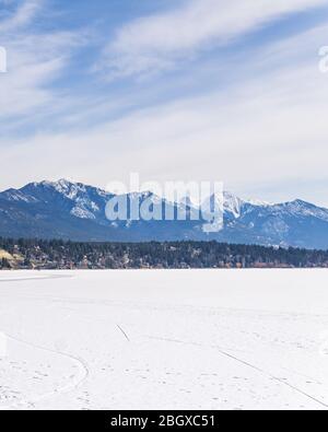frozen Windermere lake and rocky mountains in british columbia canada ...
