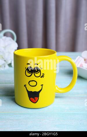 Emotional cup on wooden table Stock Photo - Alamy