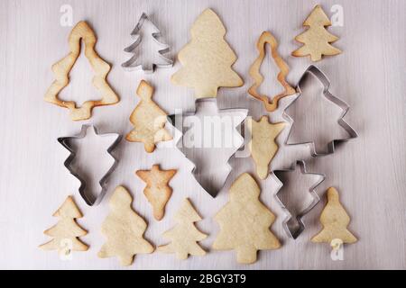 Holiday tree copper cookie cutter full of rose gold rounds on blue ...