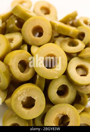 Cut fresh green olive rings in bowl isolated on white Stock Photo - Alamy