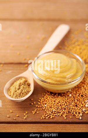 Composition of different kinds of mustard on color wooden background ...
