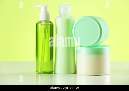 Cosmetic bottles on light green background Stock Photo - Alamy