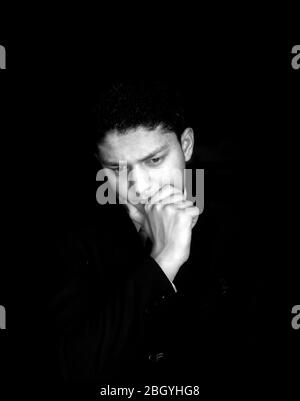 Confused businessman wearing blue suit jacket and white shirt sitting ...